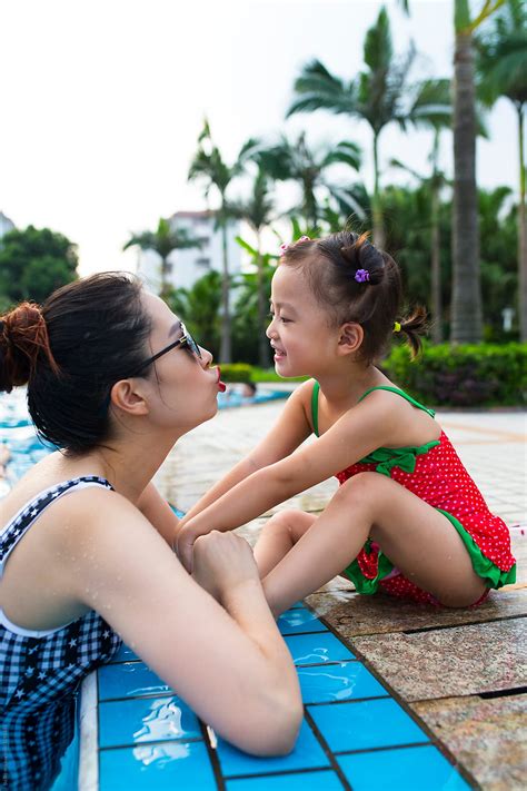 Woman And Her Daughter In The Swimming Pool By Stocksy Contributor