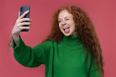 Free Photo Portrait Of Teenage Girl Taking A Selfie And Sticking Her