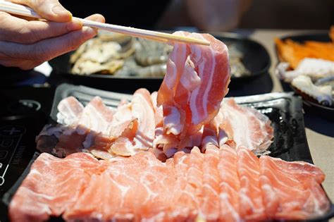 손을 잡고 일본 냄비로도 알려진 샤 브 샤 브 나 전골 젓가락을 사용 하 여 원시 돼지고기 기선에 대한 스톡 사진 및 기타