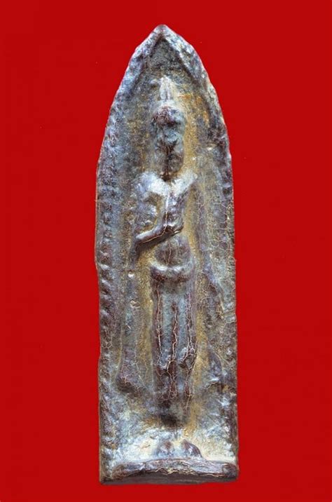 An Old Metal Object With A Woman Holding A Bird On Its Back And Red