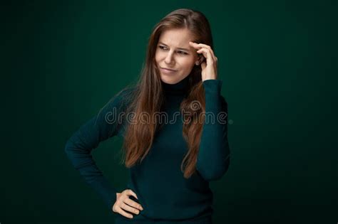 Cute Slender Woman With Brown Eyes And Brown Hair Looks Puzzled To The Side Stock Photo Image