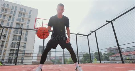 Male Basketball Player Practicing Ball Handling Skill On Basketball