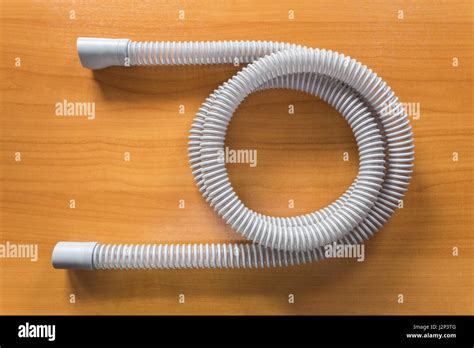 Cpap Air Hose On Wooden Table Use With Cpap Machine And Mask To Help