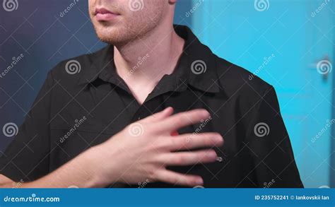 A Young Caucasian Male In A Medical Uniform Self Massage His Chest