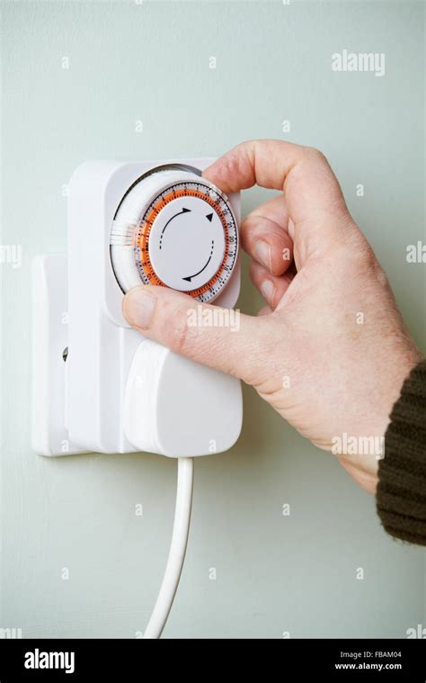 Man Adjusting Timer On Electrical Socket Stock Photo Alamy