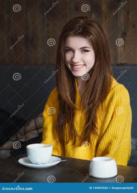 Portrait Of A Cute Pretty Redhead Smiling Woman Sitting In A Cafe