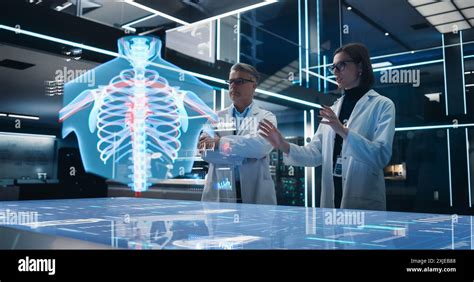 Two Bioengineers Working With Computer Powered Vfx Hologram Of Human
