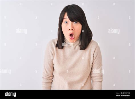 Young Beautiful Chinese Woman Wearing Turtleneck Sweater Over Isolated White Background Afraid