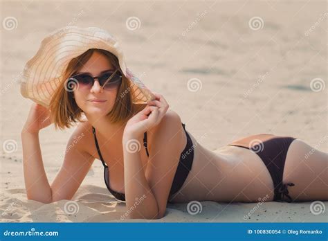 Portrait Of A Smiling Beautiful Caucasian Young Woman In A Glass Stock