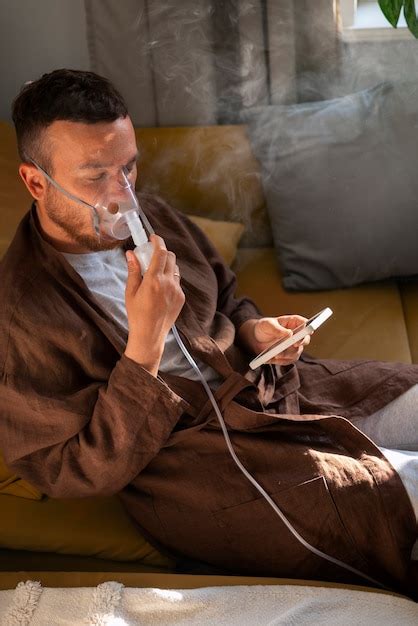 Free Photo High Angle Man Using A Nebulizer