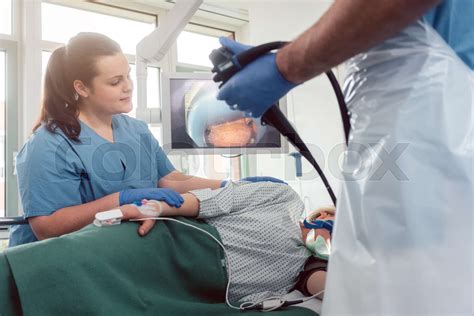 Doctor During Endoscopy Checking Picture Of Mouth On Screen Stock