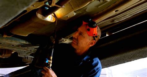 A Middle Aged Caucasian Man Works On A Vehicles Undercarriage With Copy Space From Pikwizard