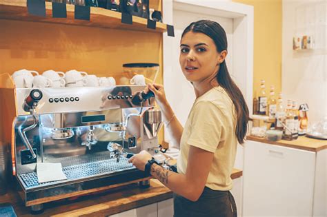 커피 숍에서 전문 커피 양조 바리 스타는 작은 카페에서 따뜻하고 아늑한 분위기의 커피 머신에서 커피 컵을 만듭니다 25 29세에 대한 스톡 사진 및 기타 이미지 Istock