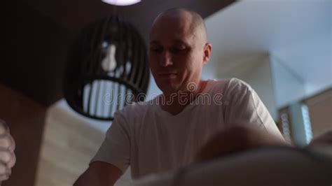 Close Up Face Of Serious Focused Male Masseur With Strong Hands