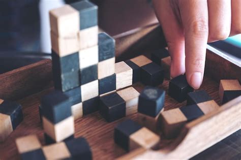 Premium Photo Midsection Of Man Stacking Blocks On Wooden Container At Home