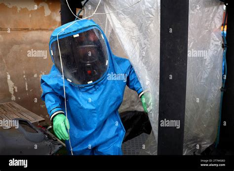 Person Wears Blue Personal Protective Equipment Ppe With Gas Mask For