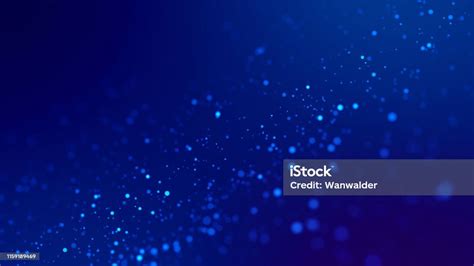 공상 과학 배경 파란색 배경에 빛나는 파란색 입자는 피사계 심도 및 가벼운 보케 효과와 밝은 축제 프리젠 테이션을 위해 공기에 매달려있습니다 버전 22 상에 대한 스톡 사진