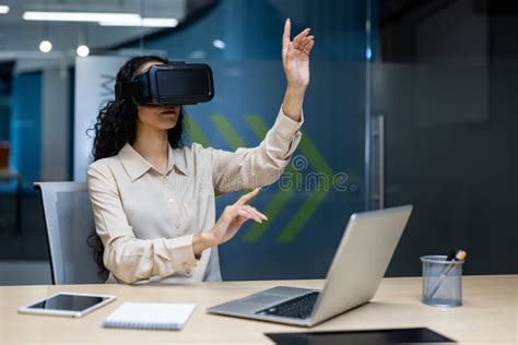 Businesswoman Using Virtual Reality Headset In Modern Office While