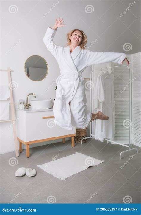 Cheerful Beautiful Woman Jumping And Dancing In The Bathroom Stock