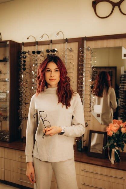 Premium Photo Woman Trying On Glasses In Optical Store