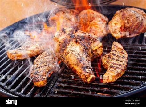 Traditional Barbecue Lamb Shanks And Saddle Grilled As Close Up On A