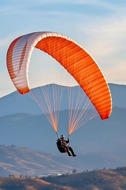 Premium Ai Image White Orange Paraglide With A Paraglider In A Cocoon Against The Background
