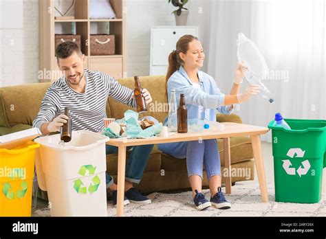 Couple Sorting Garbage At Home Concept Of Recycling Stock Photo Alamy