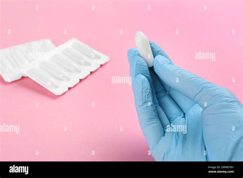 Woman Holding Suppository On Pink Background Closeup Hemorrhoid Treatment Stock Photo Alamy
