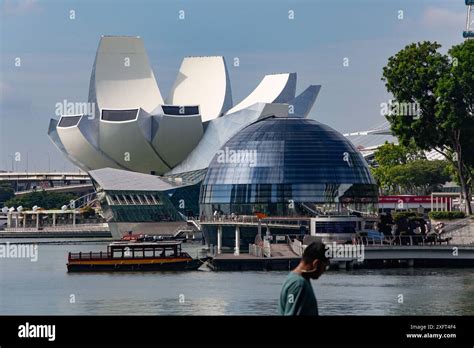 A Man Walk Pass Art Science Museum Apple Floating Store At Marina Bay