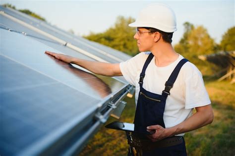 Premium Photo Worker Installing Solar Panels Outdoors