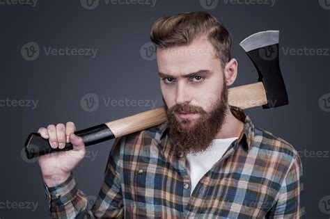 Confident Lumberjack Confident Young Bearded Man Carrying A Big Axe On Shoulder And Looking At
