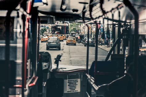 A Shot Looking Through A Public Bus Through The Windshield Onto A Street Filled With Cars And