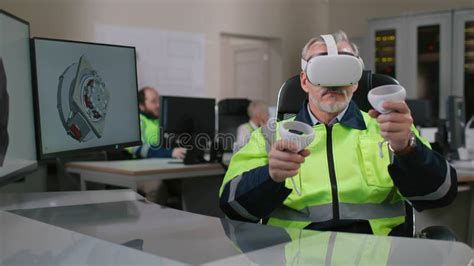 Male Industrial Engineer Wearing Virtual Reality Headset And Holding Controllers Stock Image