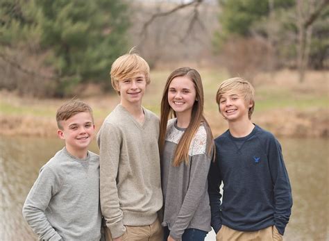 Three brothers with their sister, smiling for the camera on their ...