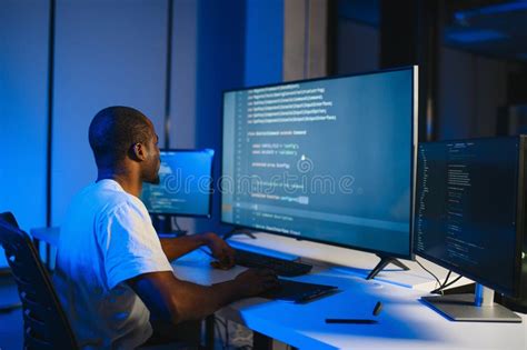 Portrait Of African American Male Programmer In Office At Night Stock
