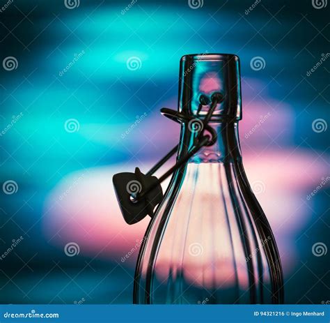 Open Glass Bottle In Front Of A Creative Coloured Background Stock