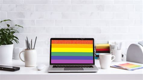 A Modern Home Office Setup With Laptop And A Rainbow Flag On Screen