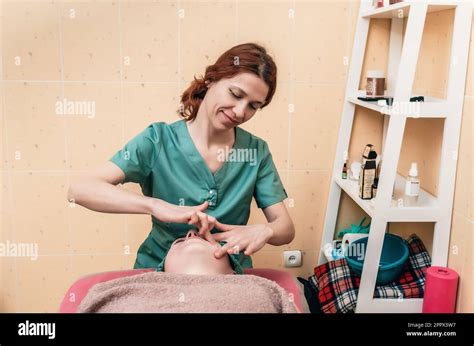 Front View Beautician Massaging Womans Face Salon Skin Care Cosmetic