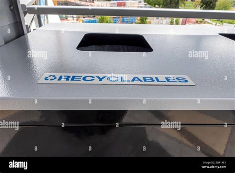 Angled View Of A Covered Grey And Black Outdoor Trash Bin Labelled For