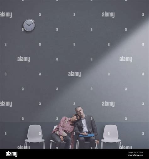 Tired People Sitting And Waiting In A Corporate Building Late At Night