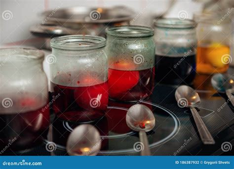 Glass Jars With Colorful Easter Eggs And Spoons Process Of Coloring