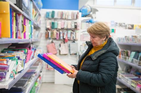 Premium Photo Portrait Of Mature Woman Between Shelves With Stationery Xa