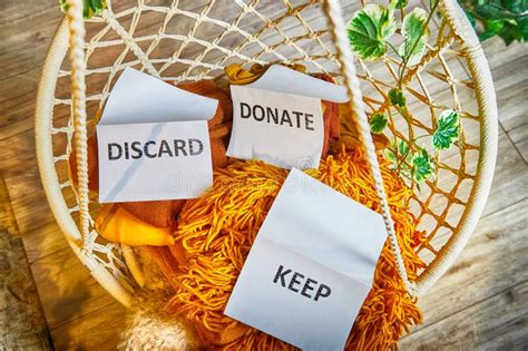 Signs With The Words Keep Donate Discard And Fashion Clothes Folded