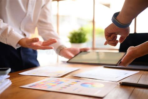 Two Young Creative Designer Working On Mobile Application Software Design Project In Office