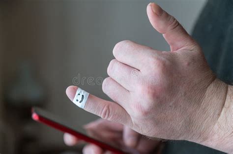 A Man Is Scrolling Through Messages On His Smartphone A Red Smartphone