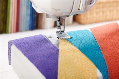 Sewing Machine With A Strips Of Fabrics On The Background Of Stack Of