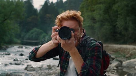 Счастливый парень с позицией камеры на реке Фотограф с фото на камеру сток видео Видео