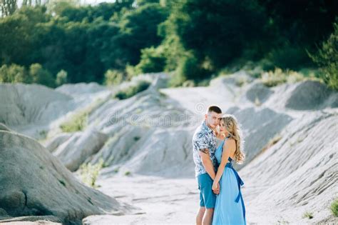 Blonde Girl In A Light Blue Dress And A Guy In A Light Shirt In A