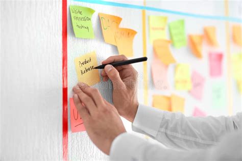 Man Writing On Sticky Note Attached To Scrum Task Board In Office Stock Photo Image Of