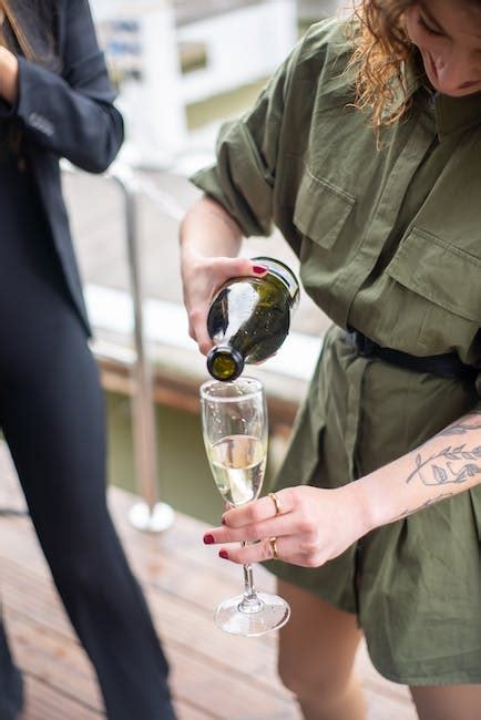 Photo Of Person Pouring Wine Into Glass Besides Some Cheese Pairings